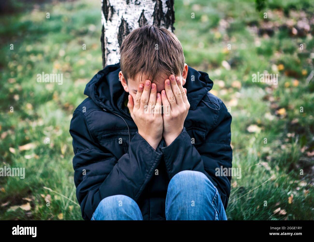 Sad Teenager sit under Tree in the Park Stock Photo - Alamy