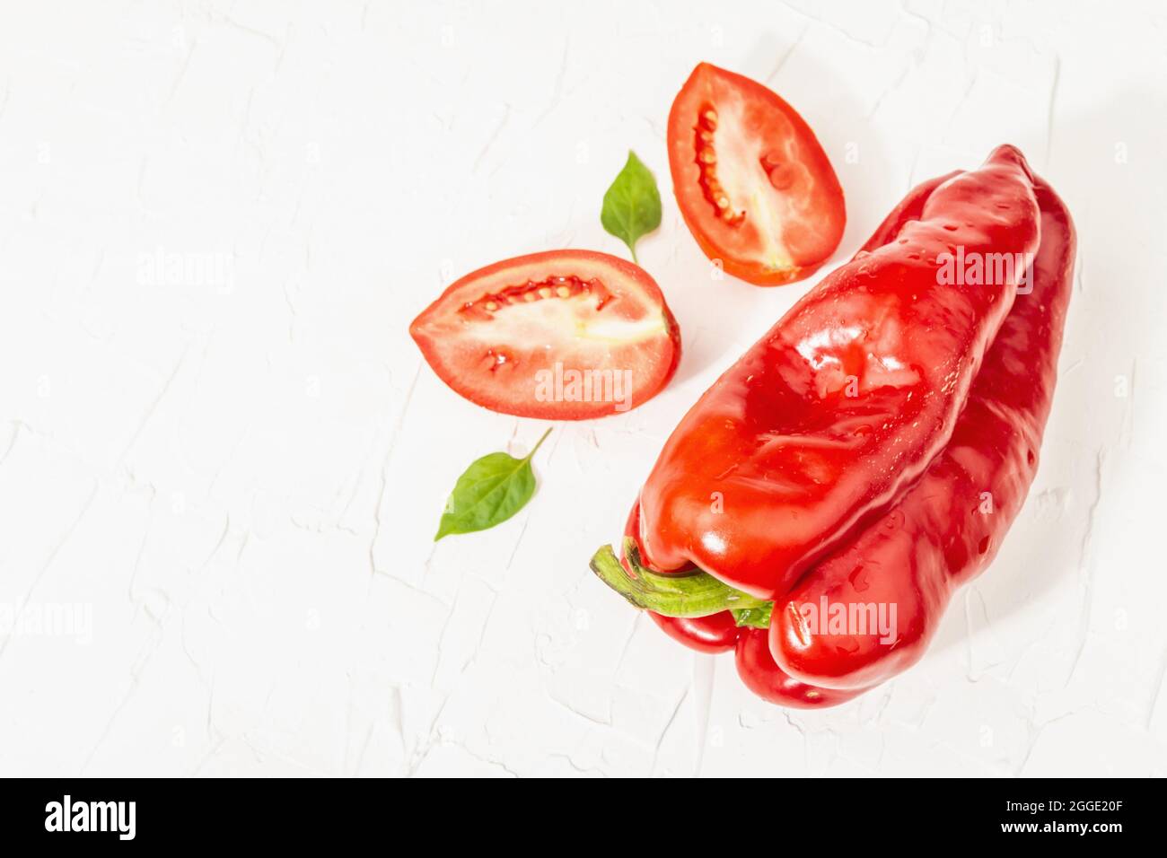 Giant red bell peppers and tomatoes on white background. Sweet ...