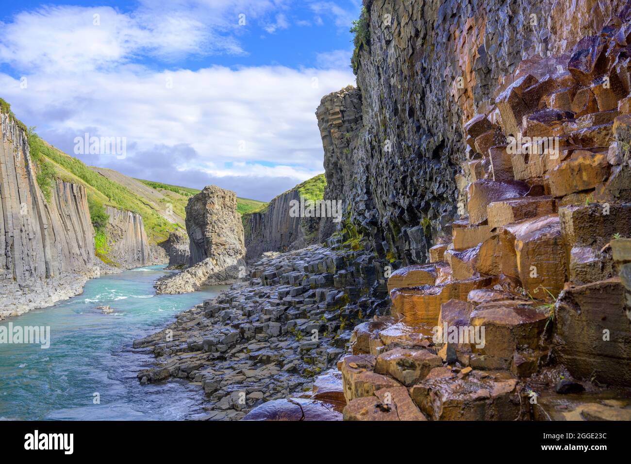 Basalt columns coloured orange by iron oxide, Stuolagil Canyon ...