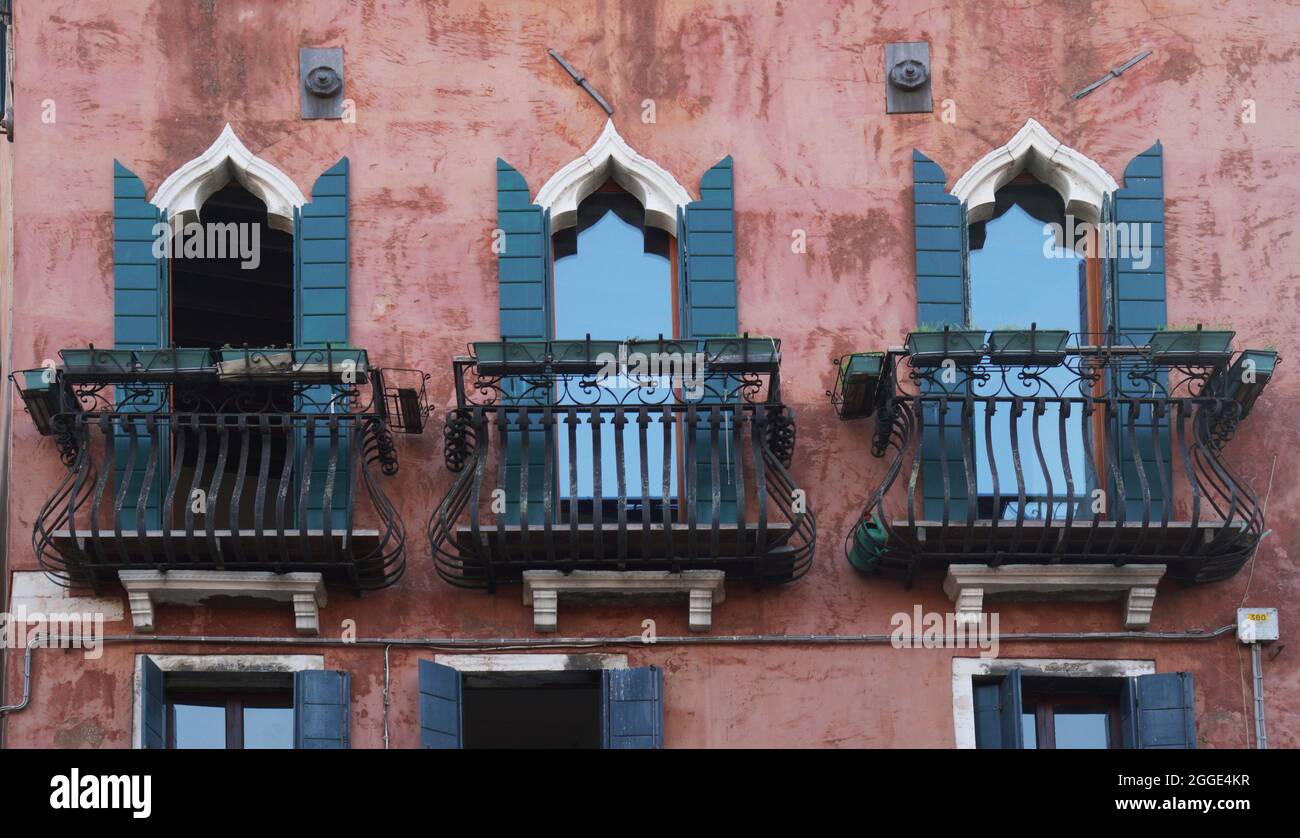 Traditional medieval balconies in a colored building, Venice, Italy ...