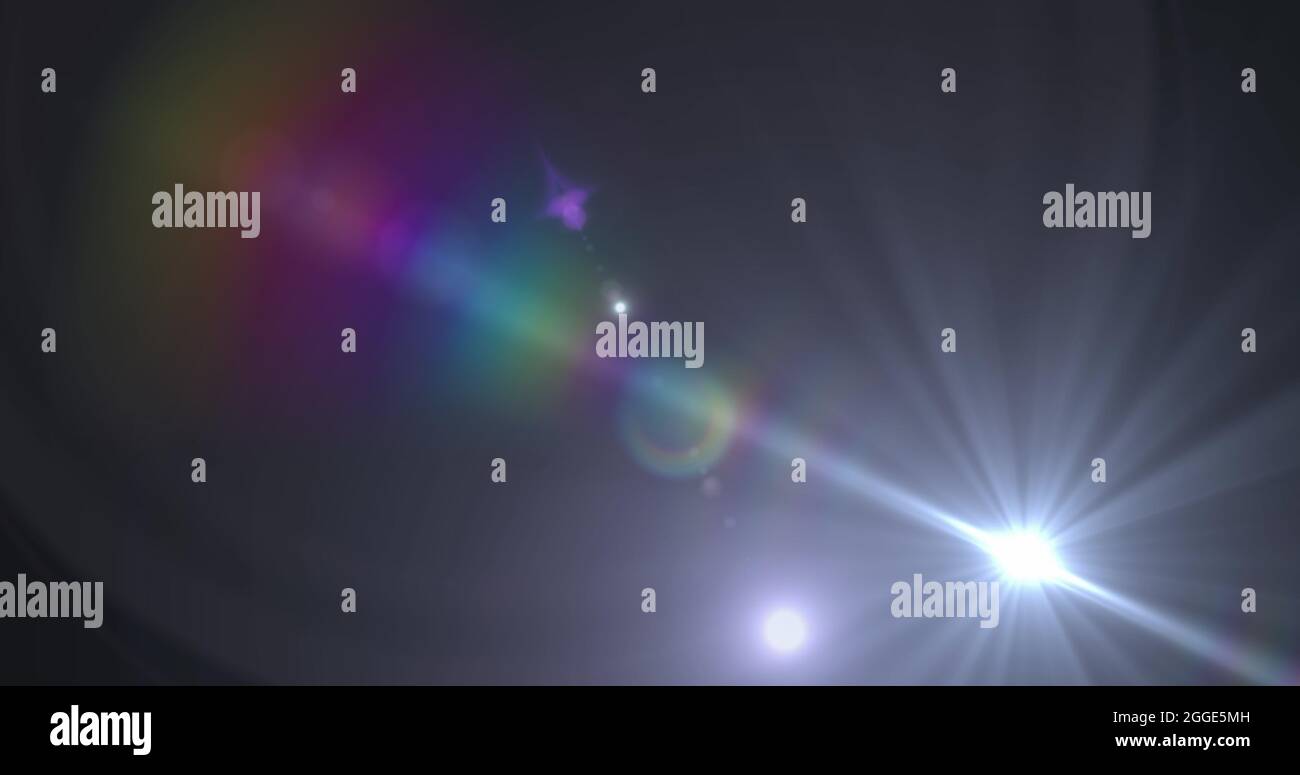 Spot of light and lens flare against black background Stock Photo - Alamy