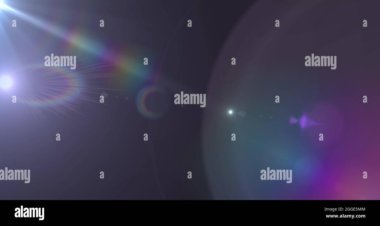Spot of light and lens flare against black background Stock Photo - Alamy