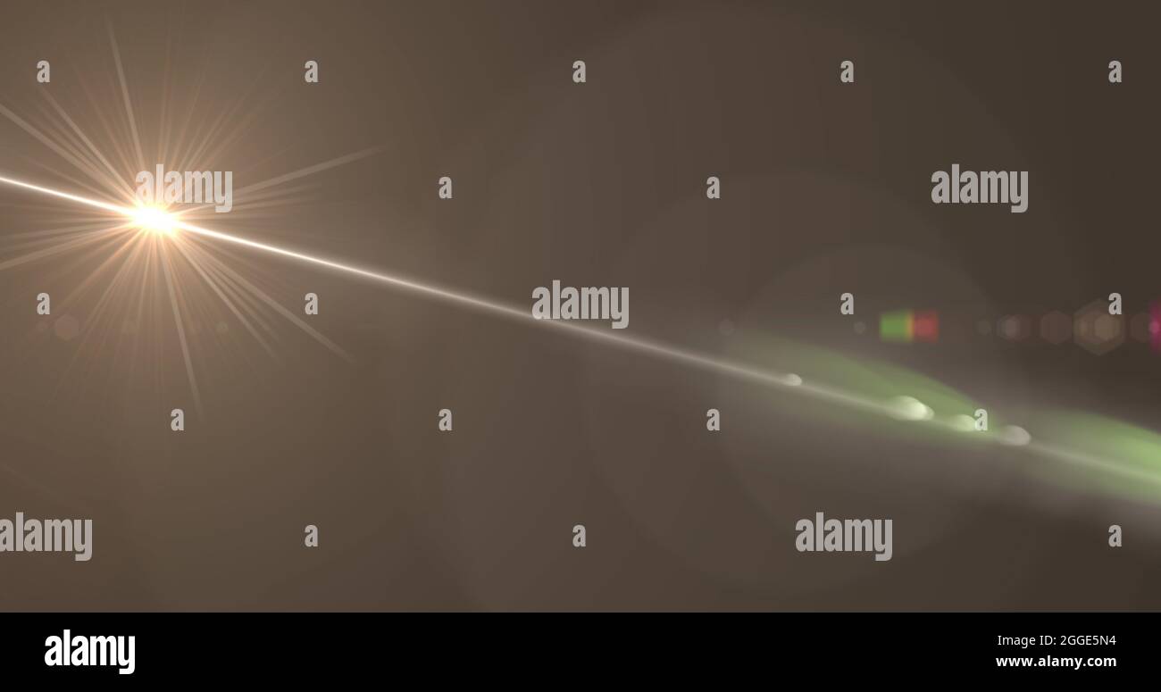 Spot of light and lens flare against black background Stock Photo - Alamy