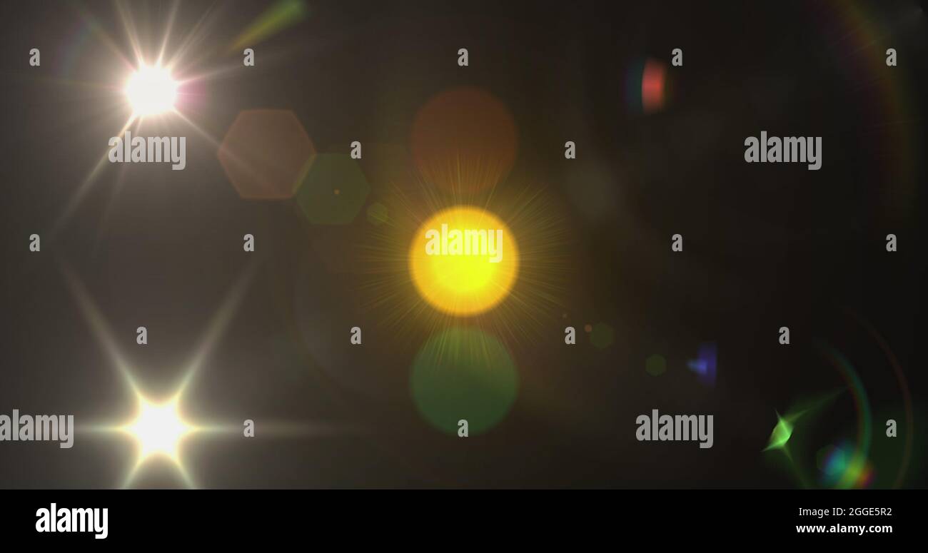 Glowing spots of light against black background Stock Photo - Alamy