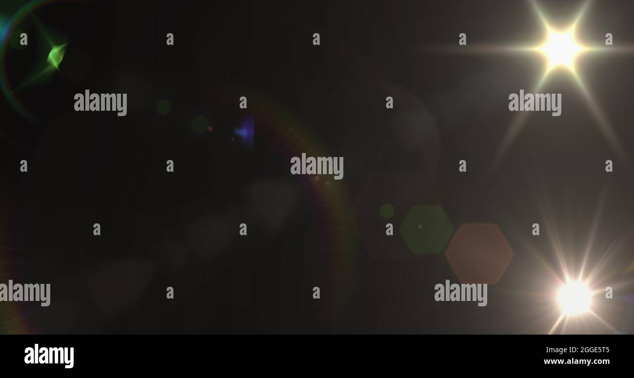 Spot of light and lens flare against black background Stock Photo - Alamy