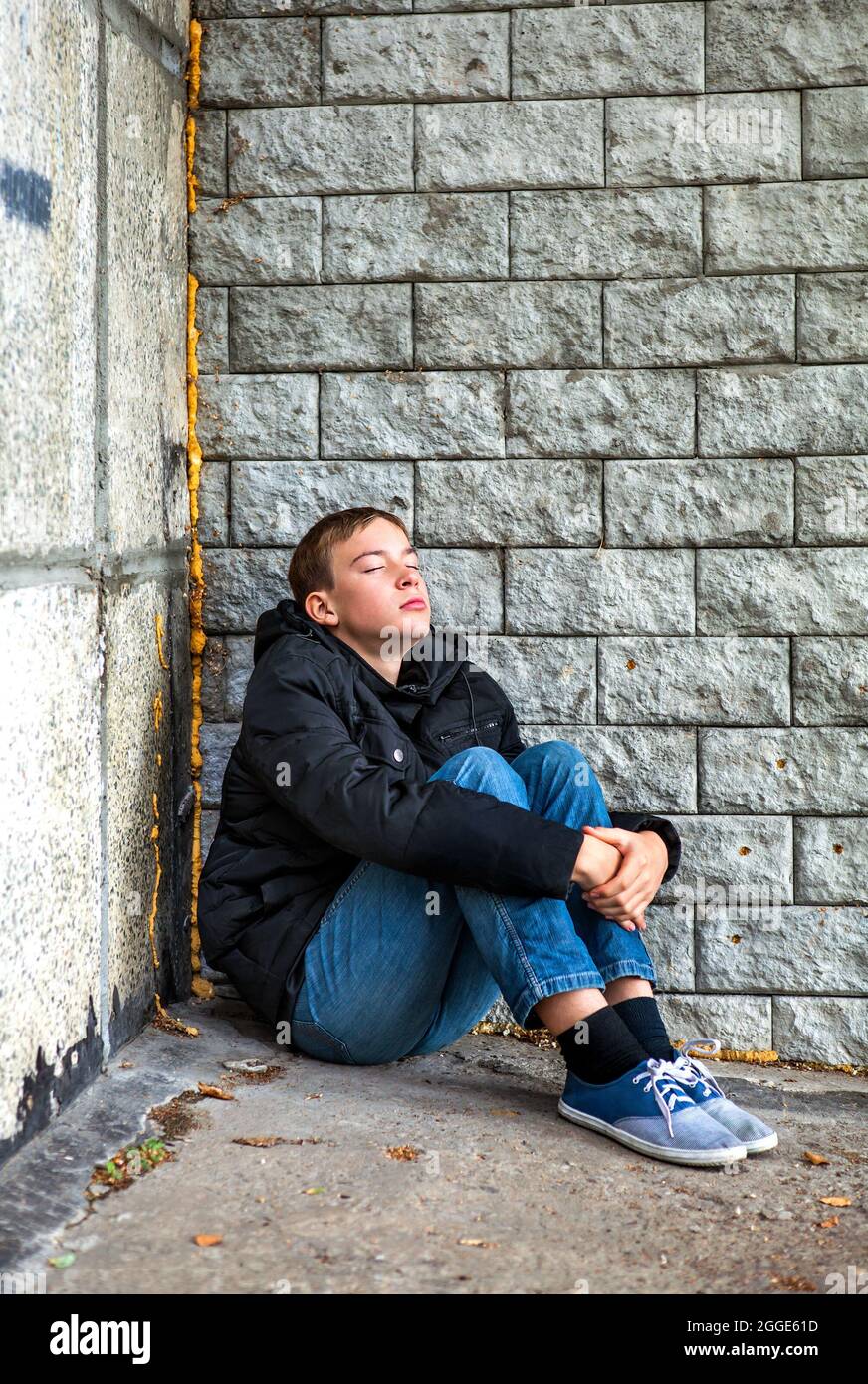 Sad Teenager sit in the Corner of the Old Building Stock Photo - Alamy
