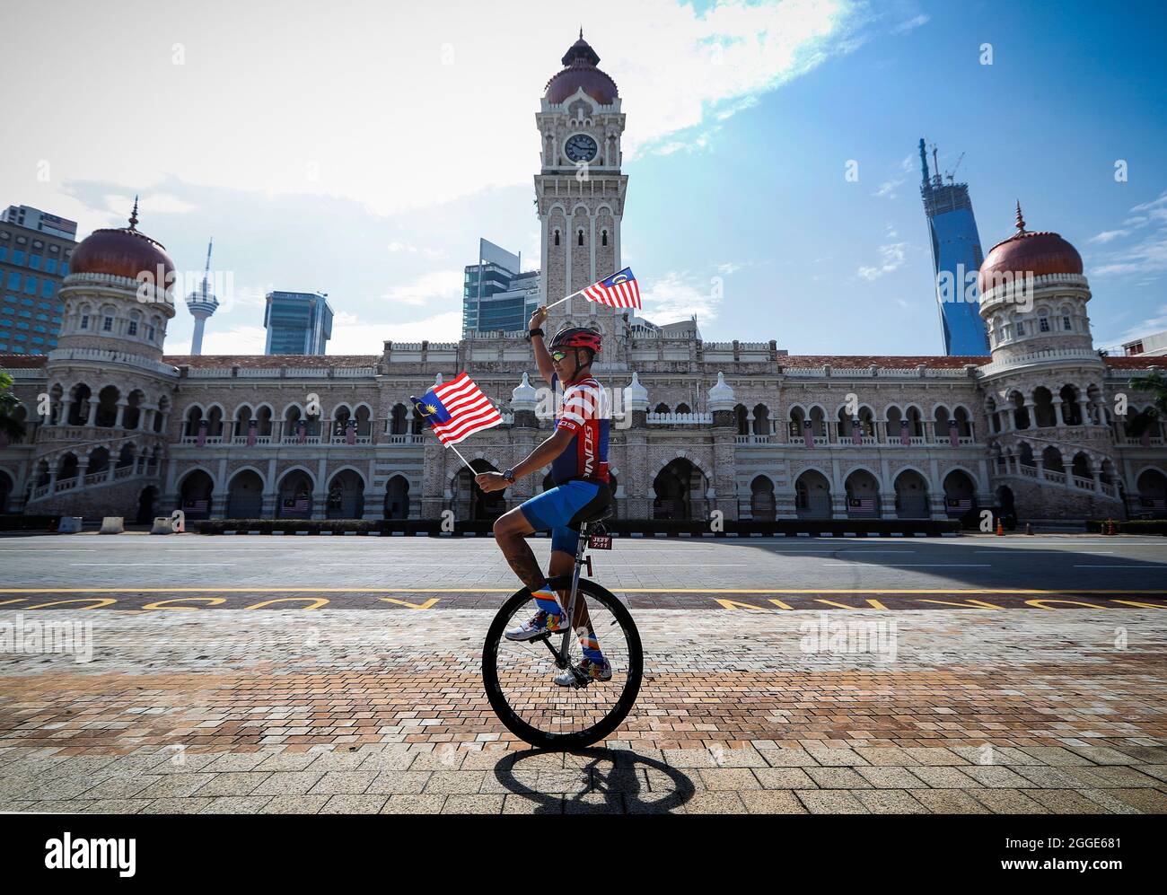 Kuala Lumpur, Malaysia. 31st Aug, 2021. A man rides a unicycle while ...