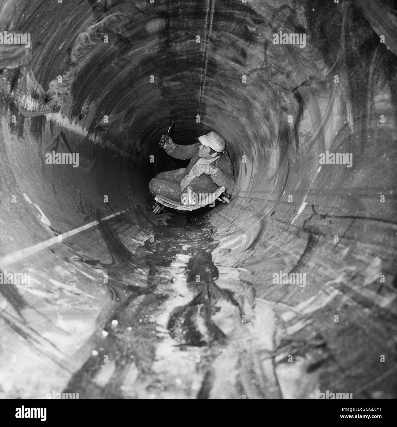 A worker repairing the epoxy resin lining on the welds inside the North ...
