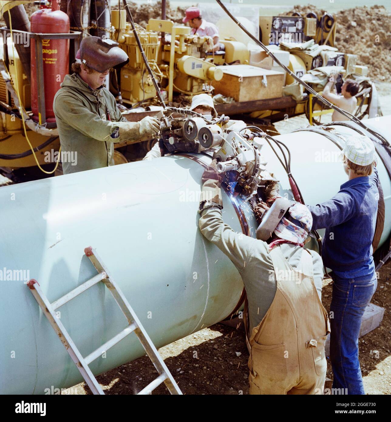 A team of welders working on the Martin pipeline, operating an ...