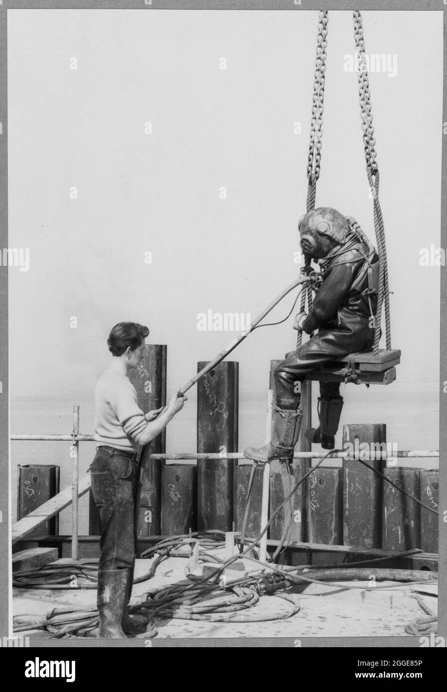 A figure in a diving suit preparing for an inspection of the works at ...