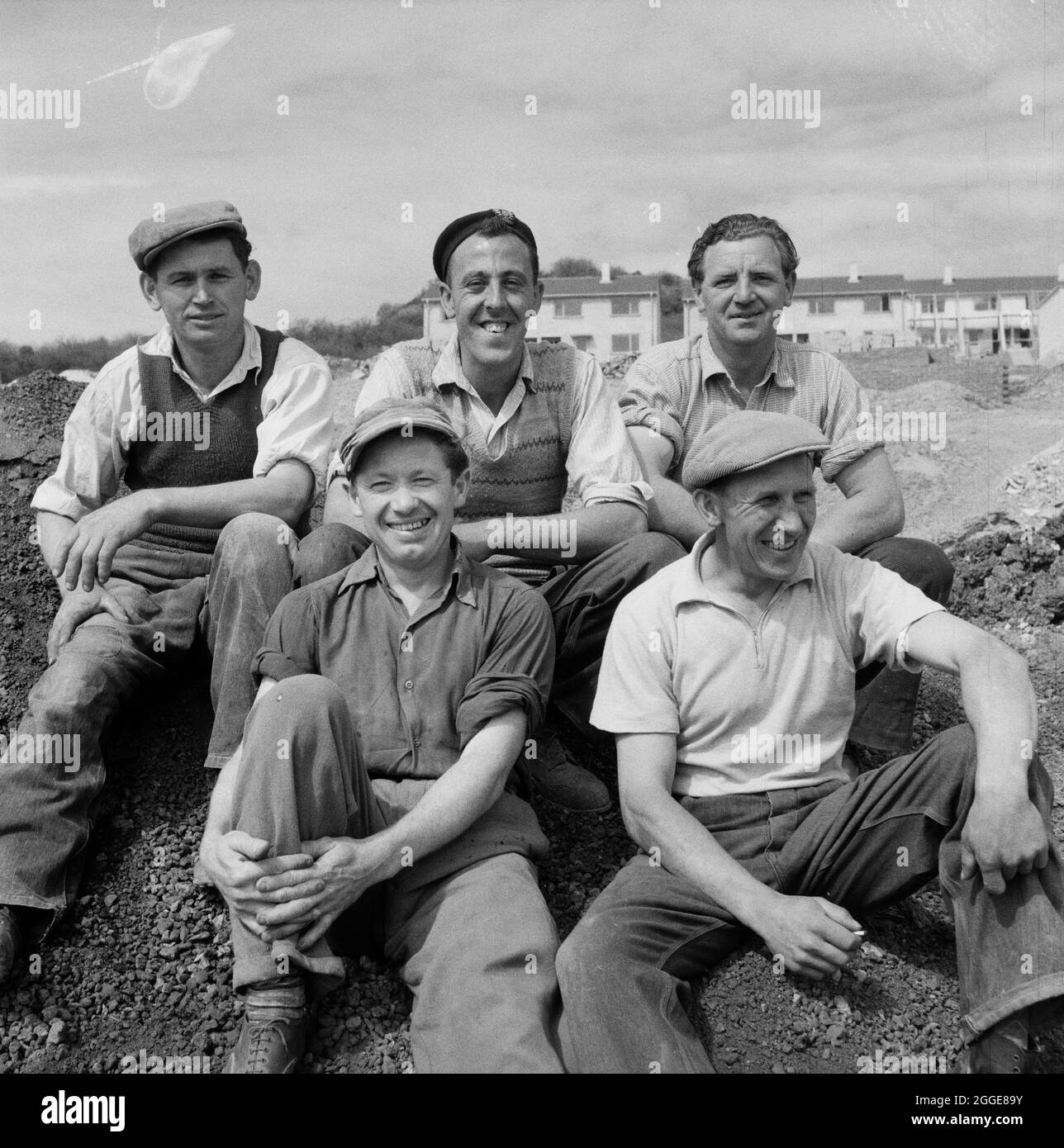 A group portrait of five Laing workers involved in the construction of ...