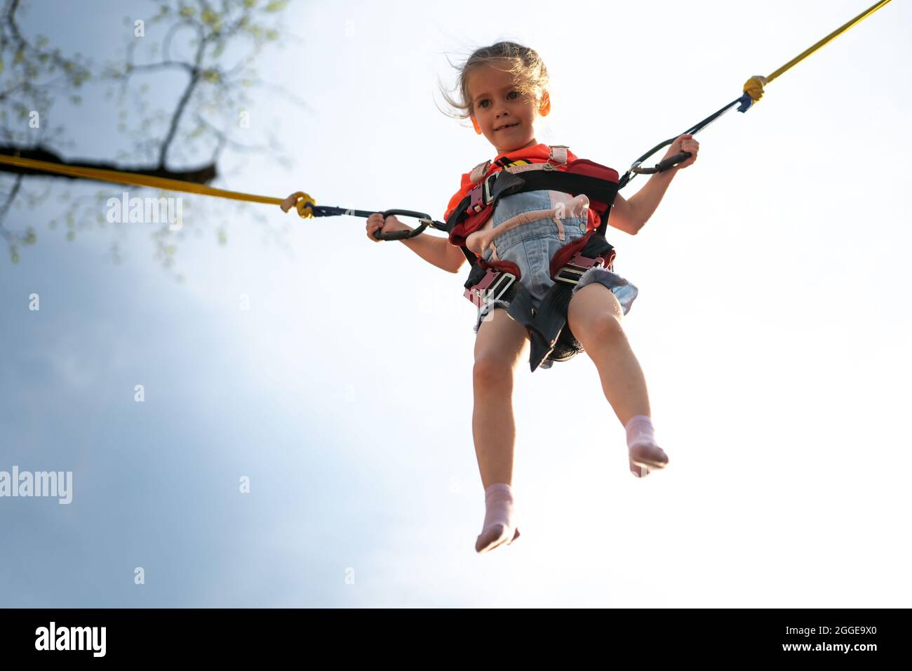 Child jumping child trampoline rubber bands Amusement park Little girl ...