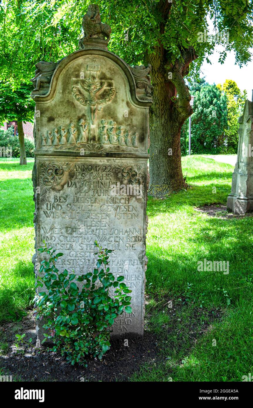 Historic sandstone gravestone from the 18th century in the churchyard ...