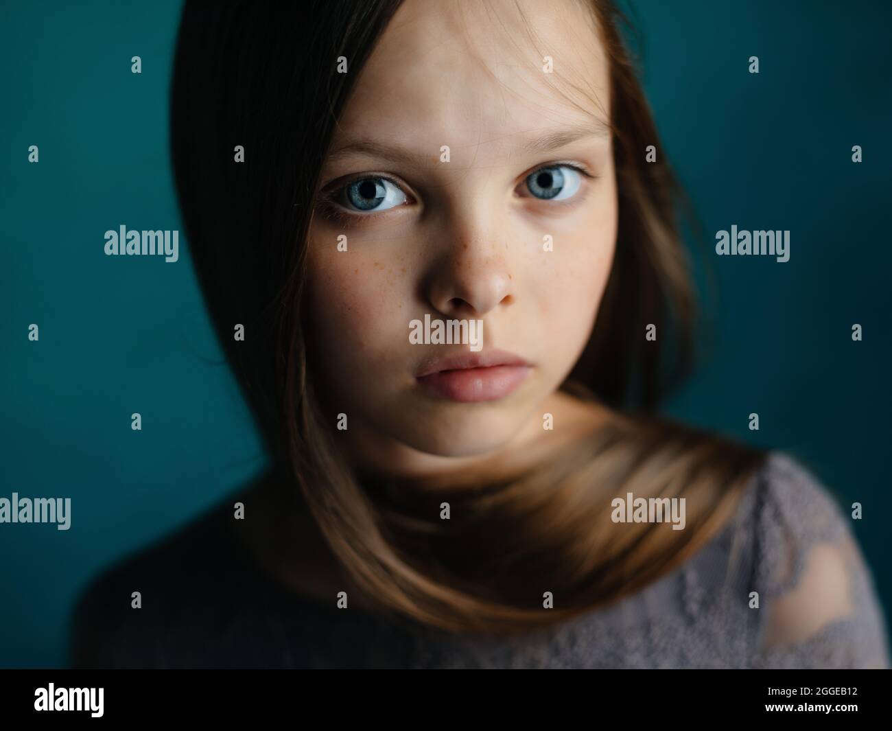 cute girl emotions depression green background Stock Photo - Alamy