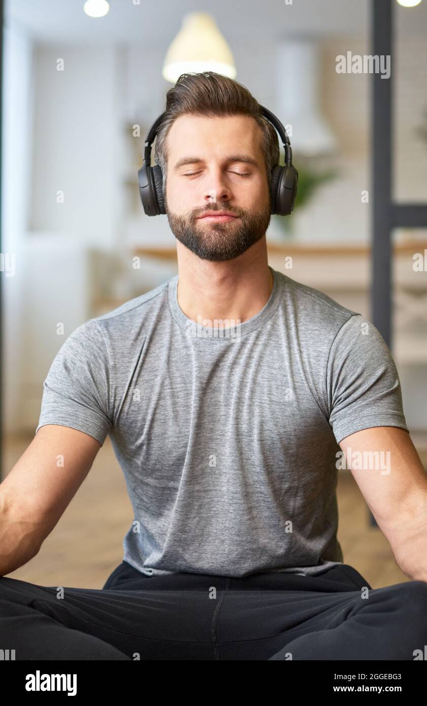 Handsome young man meditating hi-res stock photography and images - Alamy