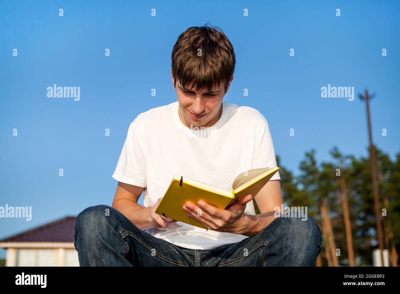 Young guy opened book hi-res stock photography and images - Alamy