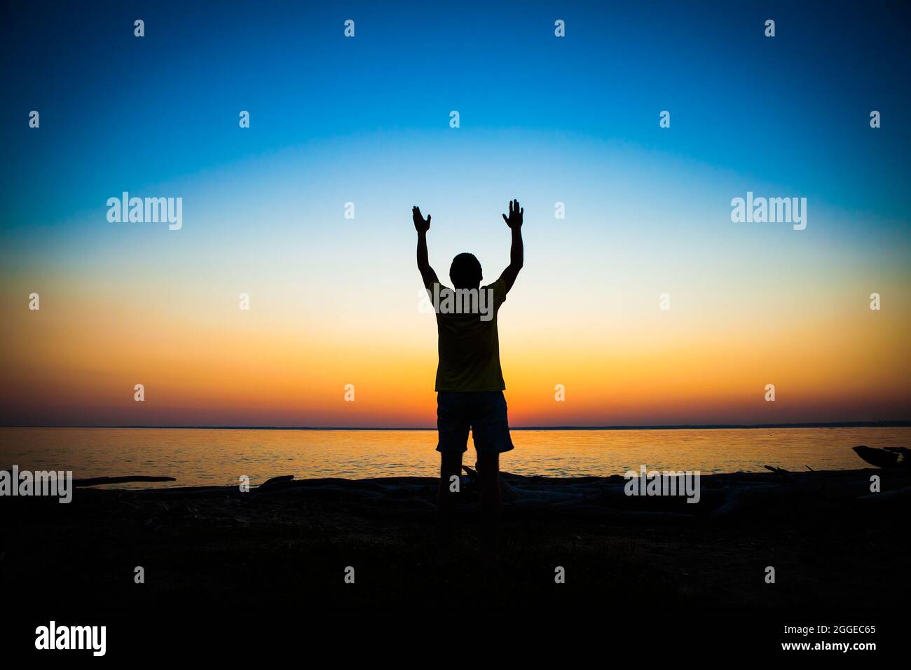 Man Silhouette Praying at the Sunset on the Sea Background Stock Photo ...