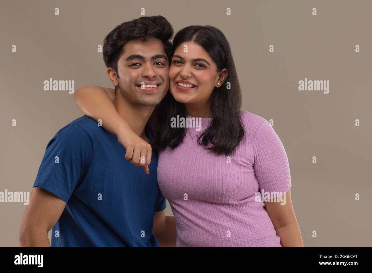 A YOUNG WOMAN HAPPILY POSING WITH YOUNGER BROTHER Stock Photo - Alamy