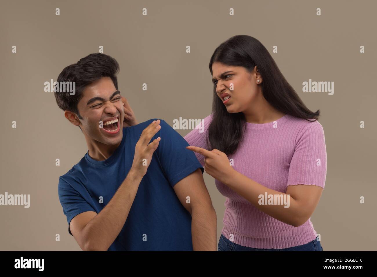 AN EXPRESSIVE WOMAN REBUKING YOUNGER BROTHER IN FUN Stock Photo - Alamy