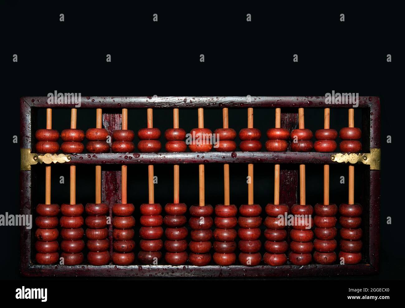 Chinese abacus (calculating aid), studio shot against black background ...
