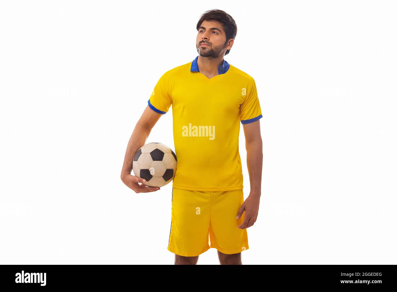 A YOUNG FOOTBALL PLAYER LOOKING ABOVE AND THINKING Stock Photo - Alamy