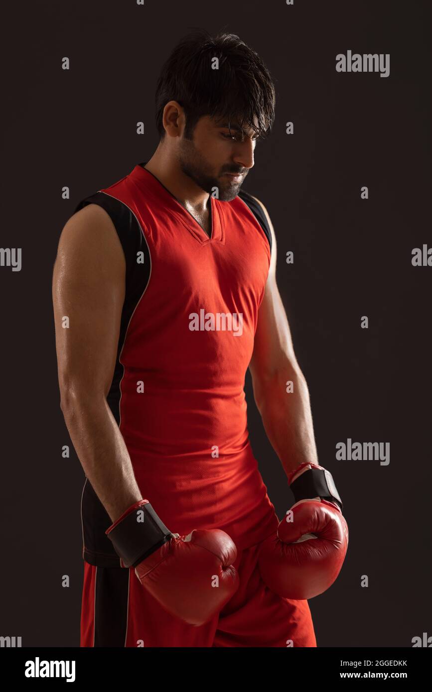 A CONFIDENT BOXER STANDING AND LOOKING DOWN WHILE THINKING Stock Photo ...