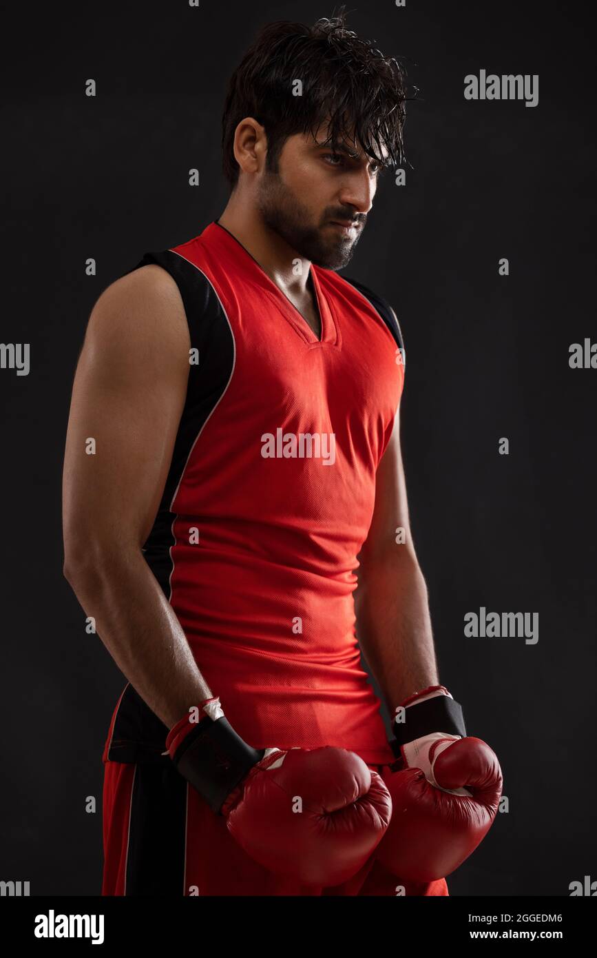 PORTRAIT OF A CONFIDENT BOXER STANDING WHILE READY TO FIGHT Stock Photo ...