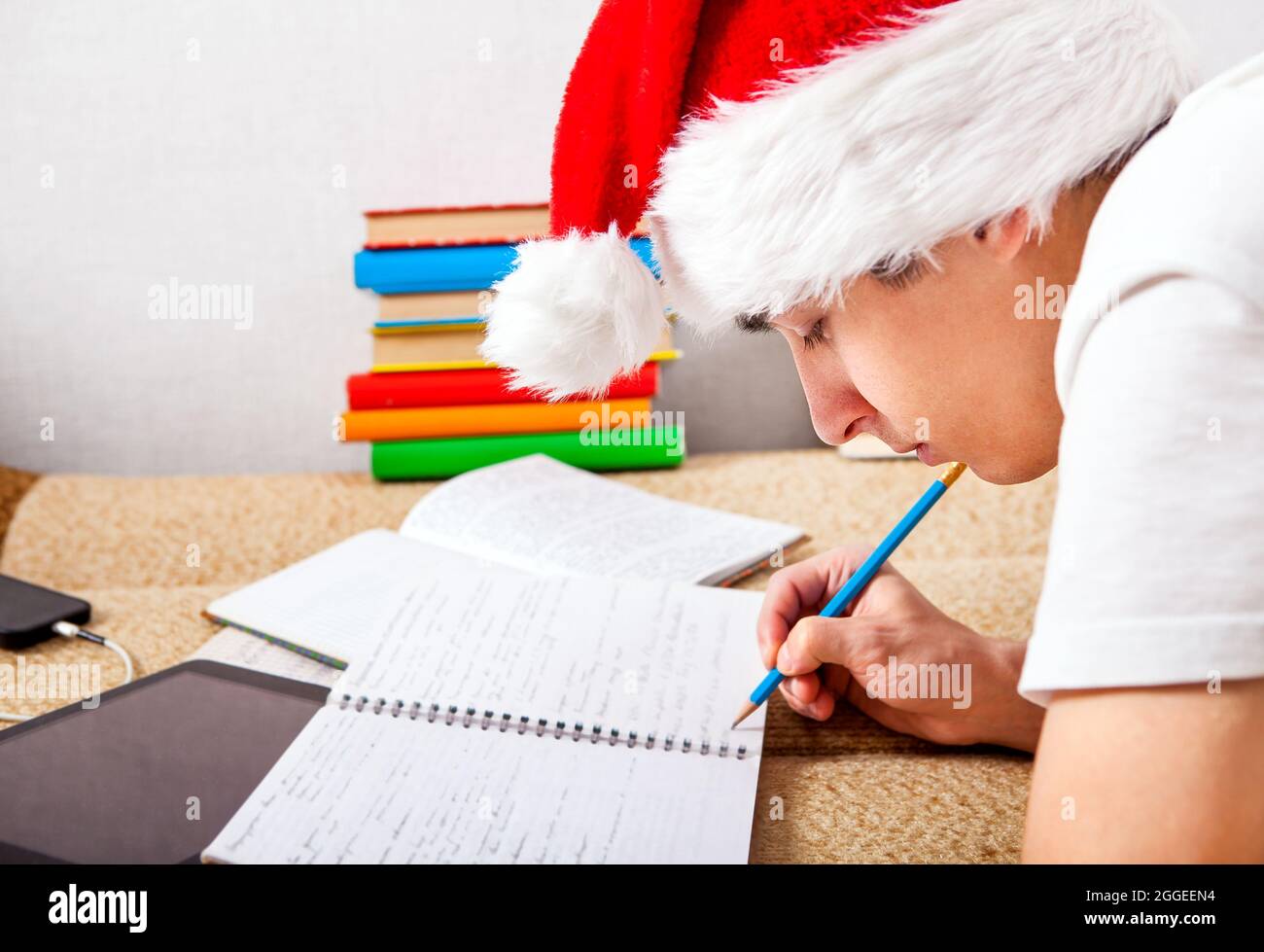 Teen doing homework on bed hi-res stock photography and images - Alamy