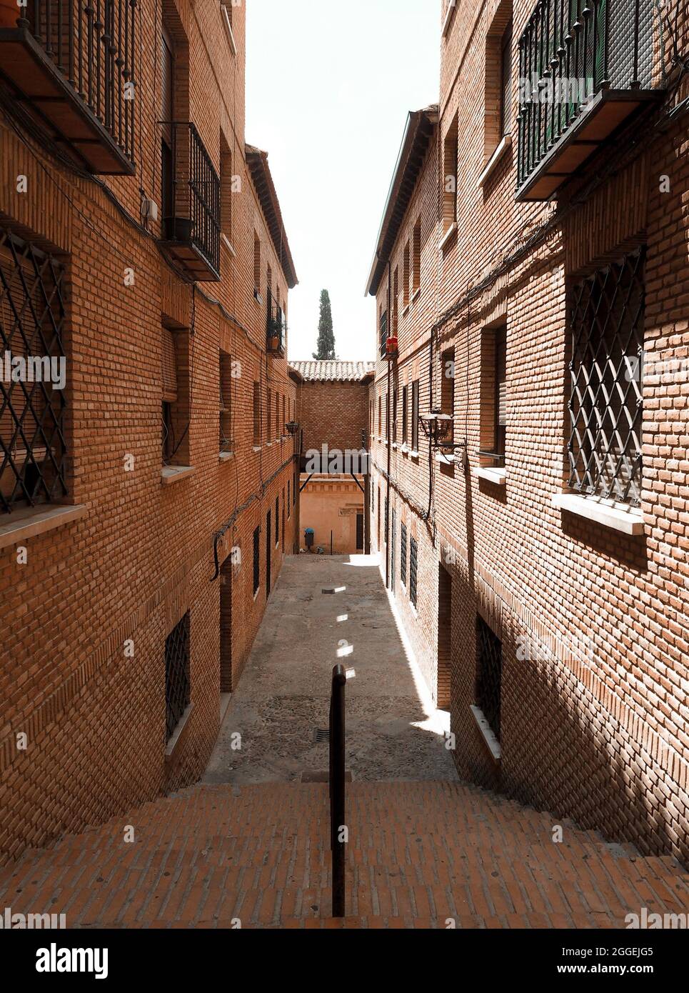 Narrow pathway between old brick-walled residential buildings Stock ...