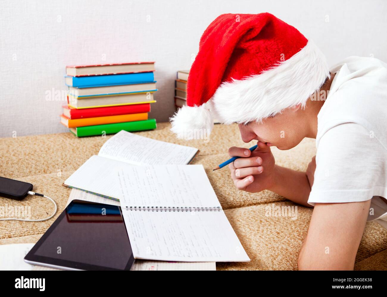 Teen doing homework on bed hi-res stock photography and images - Alamy