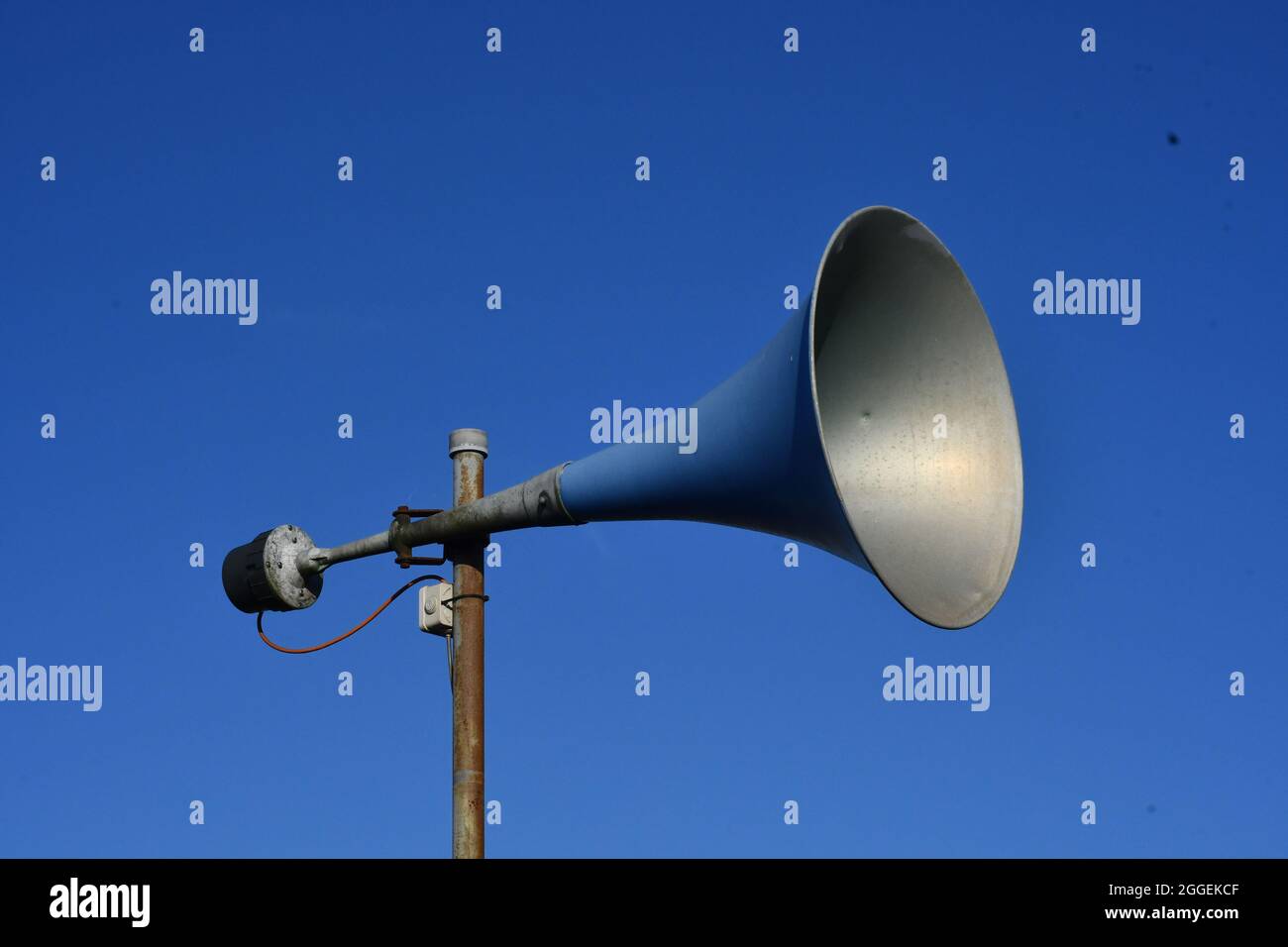 A blue and Silver Retro Megaphone with the backdrop of a clear blue sky ...