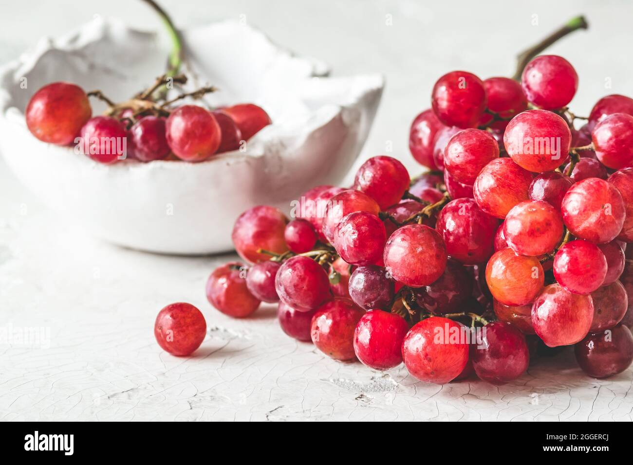 Fresh ripe red grapes on white background Stock Photo - Alamy