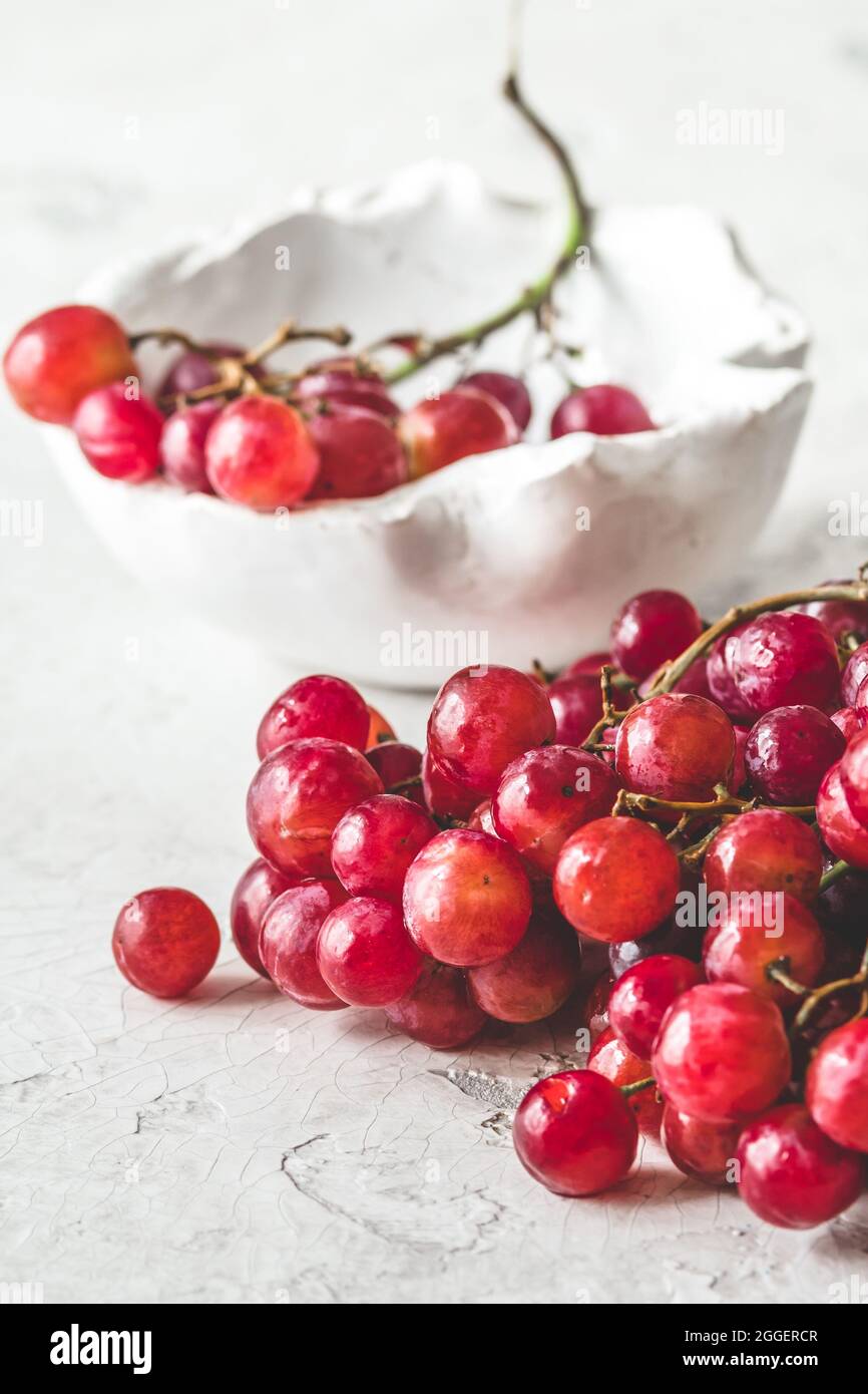 Fresh ripe red grapes on white background, vertical Stock Photo - Alamy