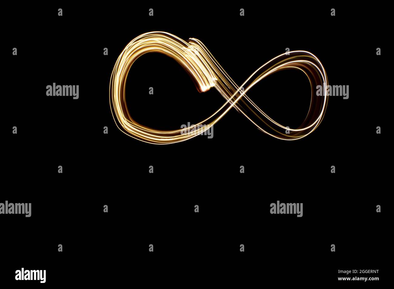 Light painting infinity sign. Drawn infinity shape with gold lights ...
