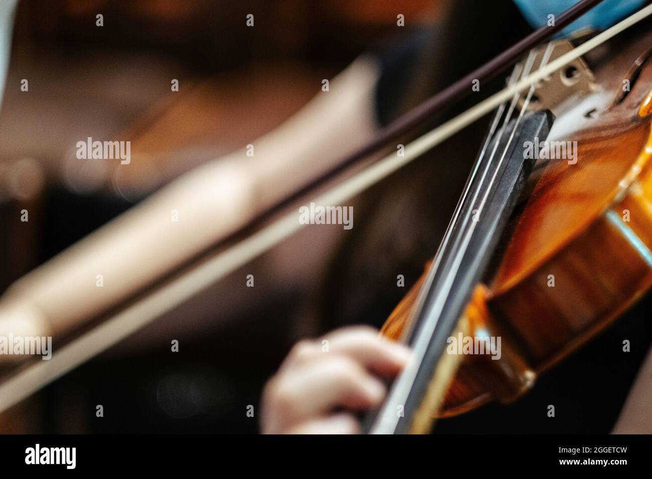 Closeup of a musician playing violin at the concert, focus on the ...