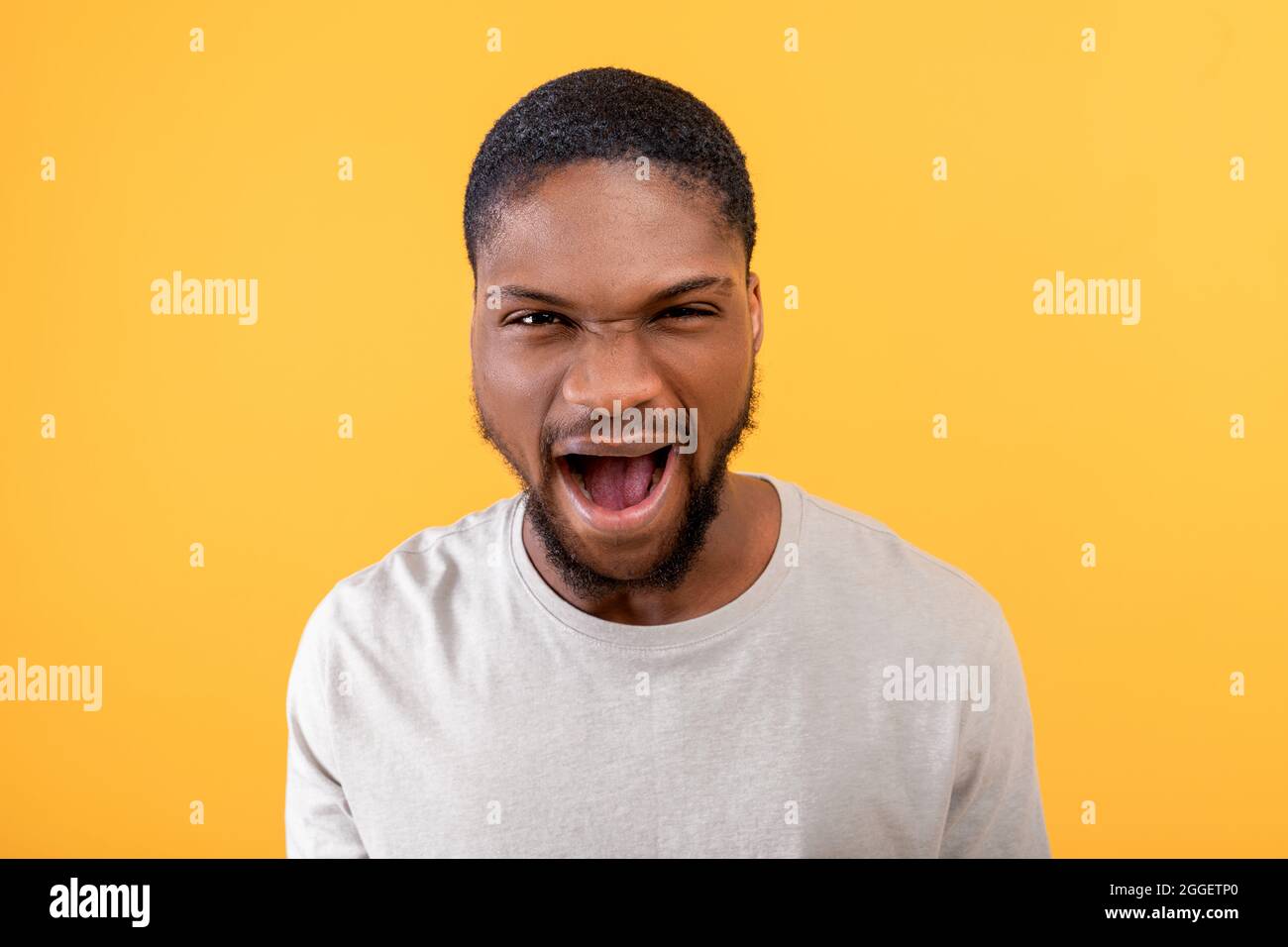 Fury. Angry black guy shouting emotionally at camera, expressing anger ...