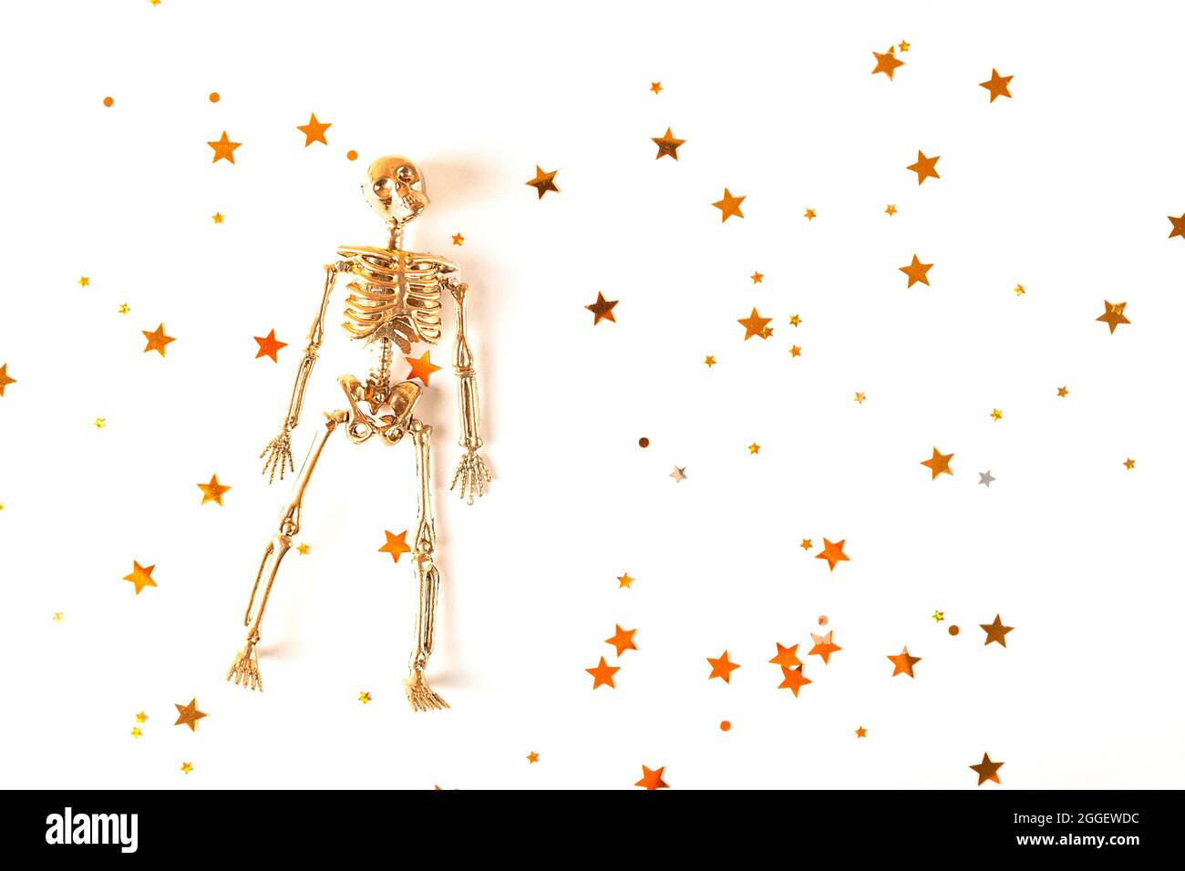 Golden skeleton on a light Halloween background with stars. Halloween ...