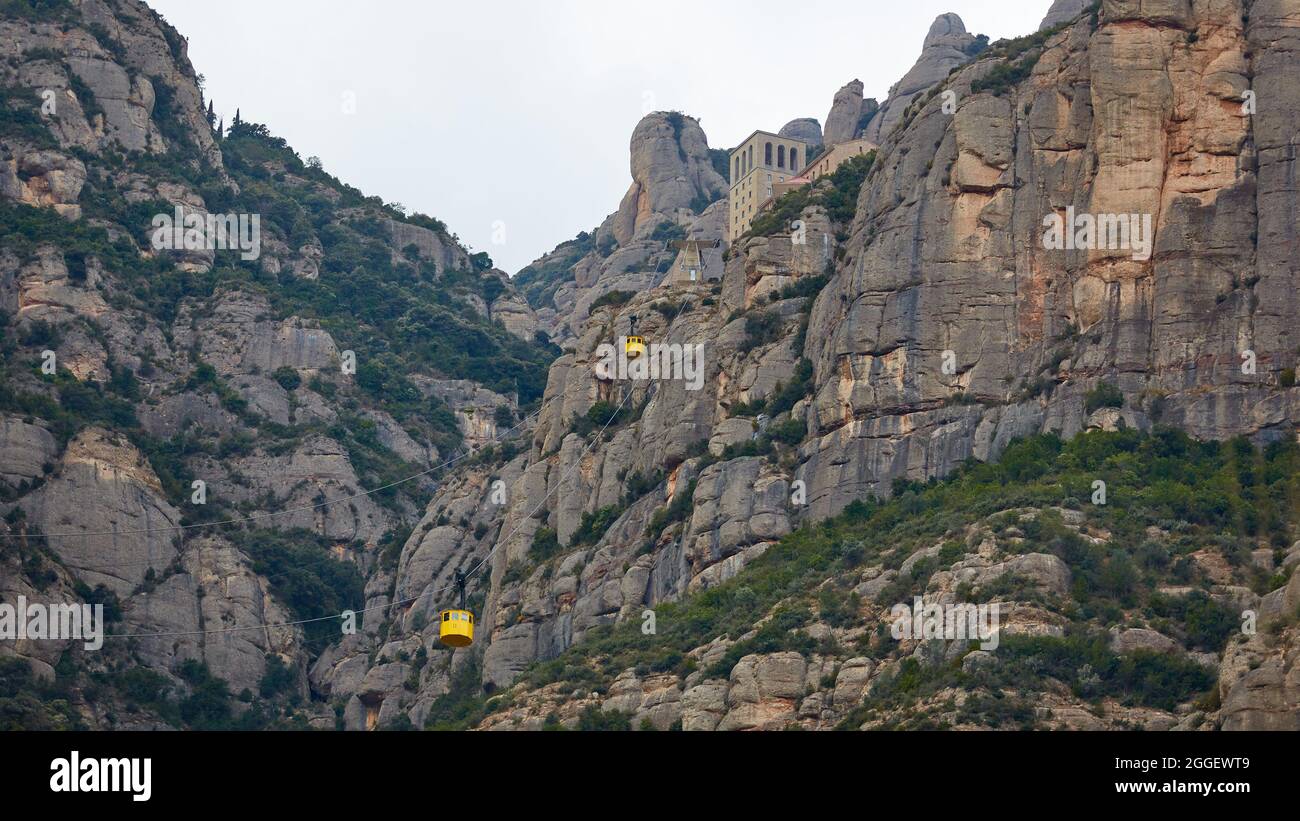 Yellow cable car in the Aeri de Montserrat rise to de Montserrat Abbey ...