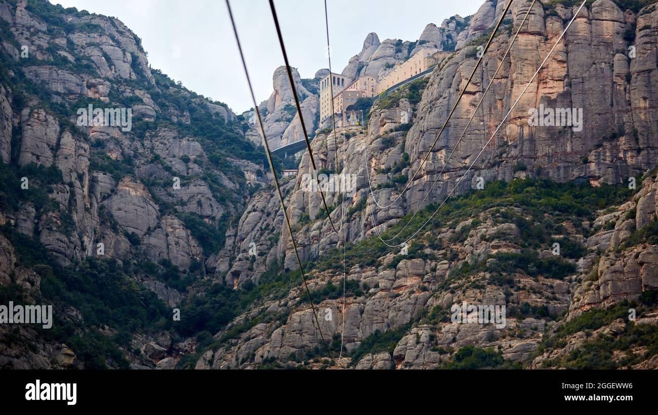 Yellow cable car in the Aeri de Montserrat rise to de Montserrat Abbey ...