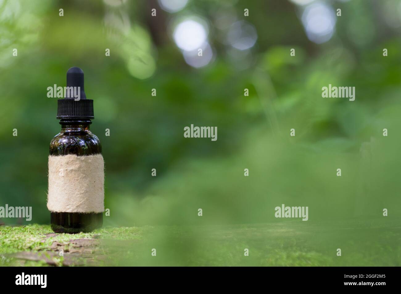 Herbal brown bottle on moss. Bokeh , blur background provides ...
