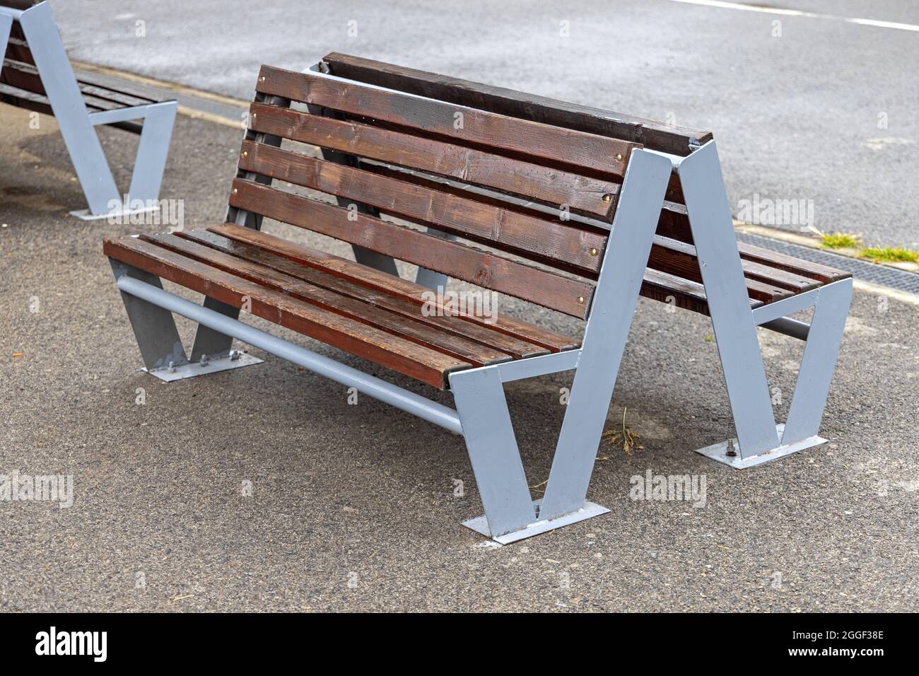Two Wooden Benches Bolted in Street Pavement Stock Photo - Alamy
