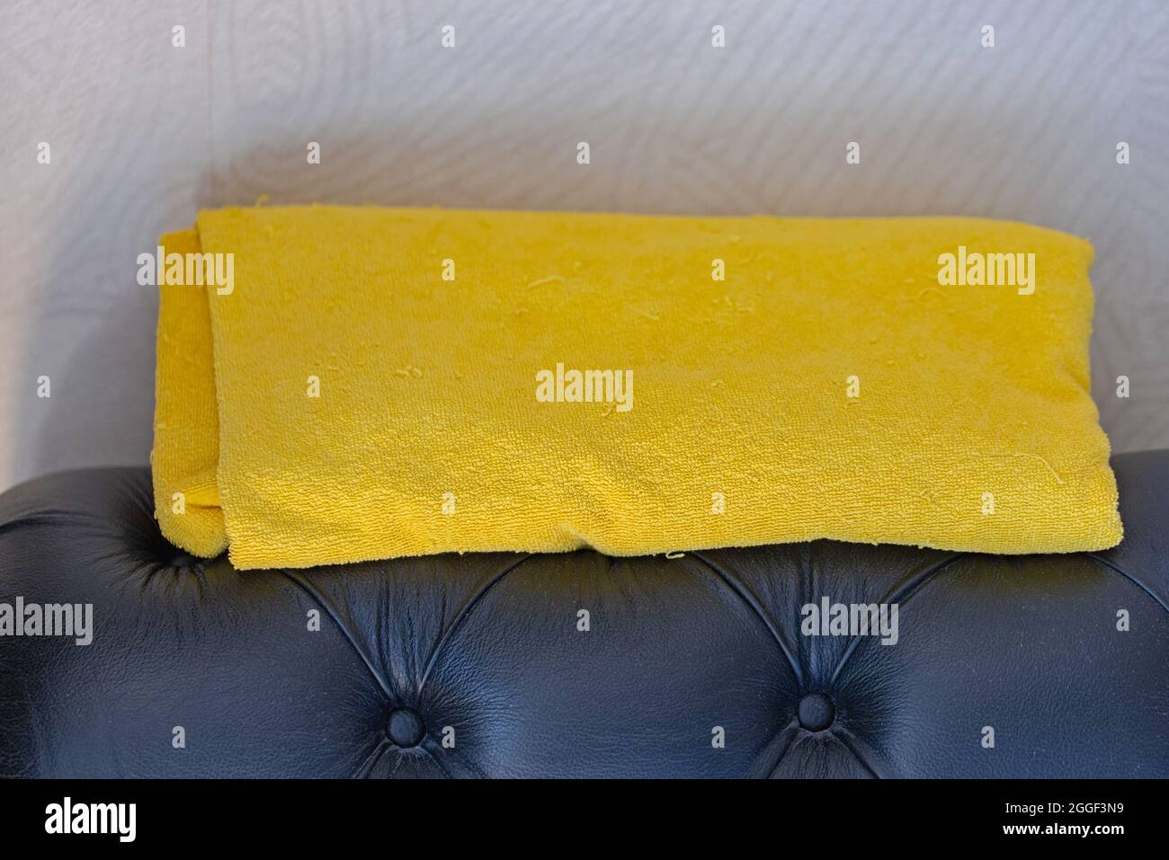 Used Yellow Terry Cloth Folded at Top of Bed Stock Photo - Alamy