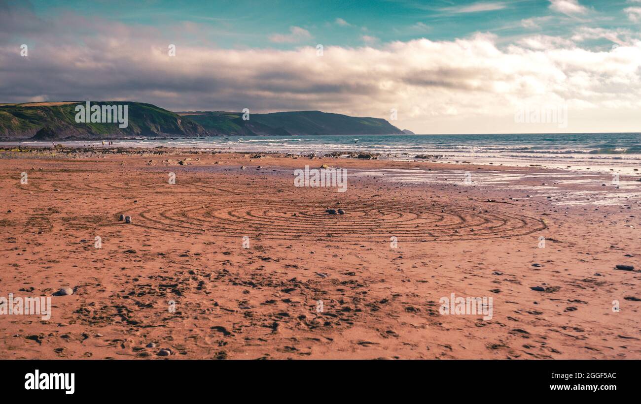 Sandy beach with circle traces on a sunset Stock Photo - Alamy
