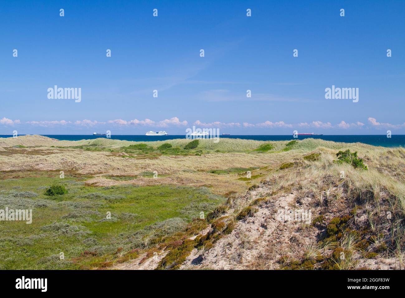 View over the dunes and the sea on ships lying at anchor near the ...