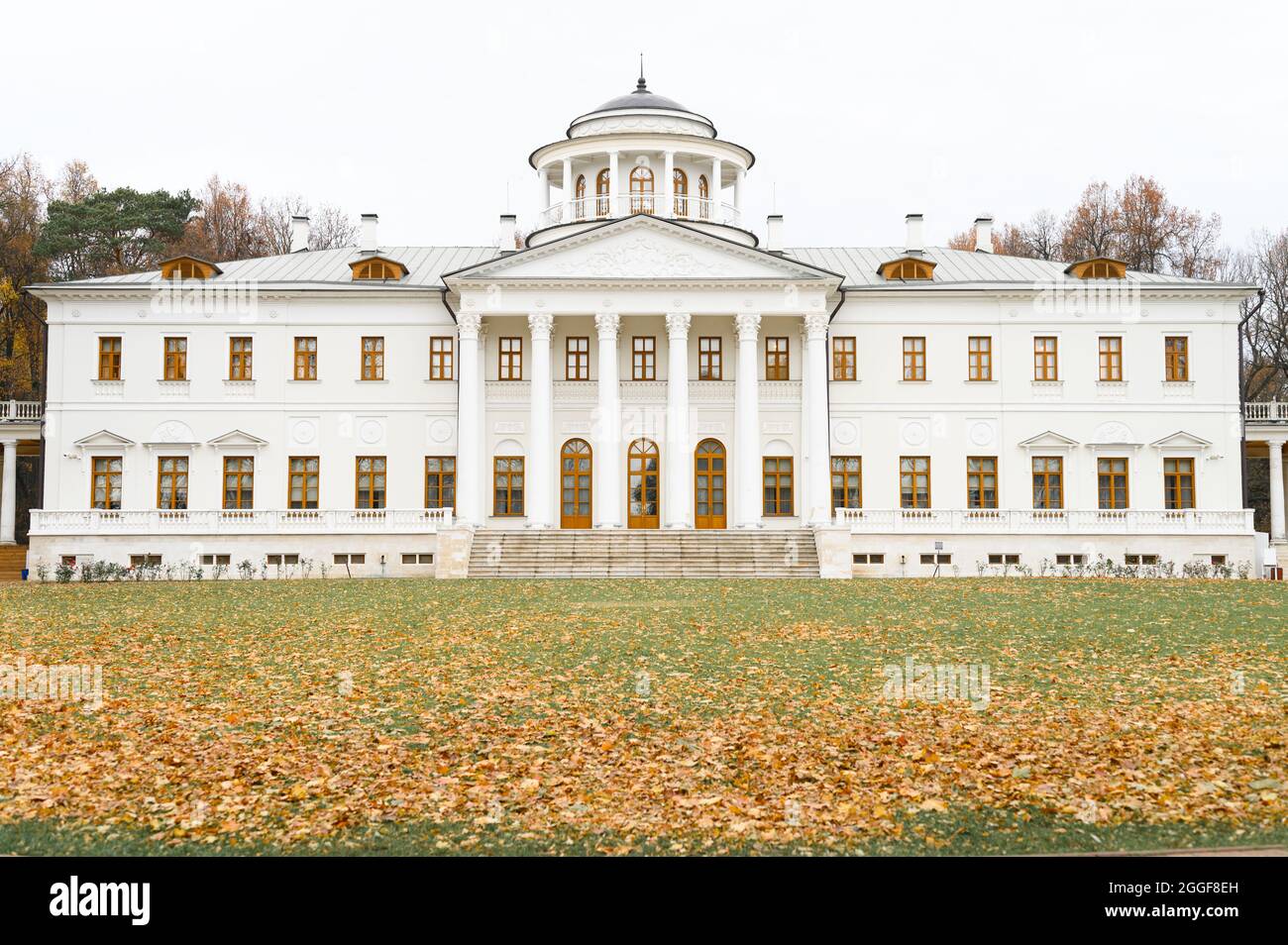 white building of the estate with columns and autumn fallen leaves of a ...