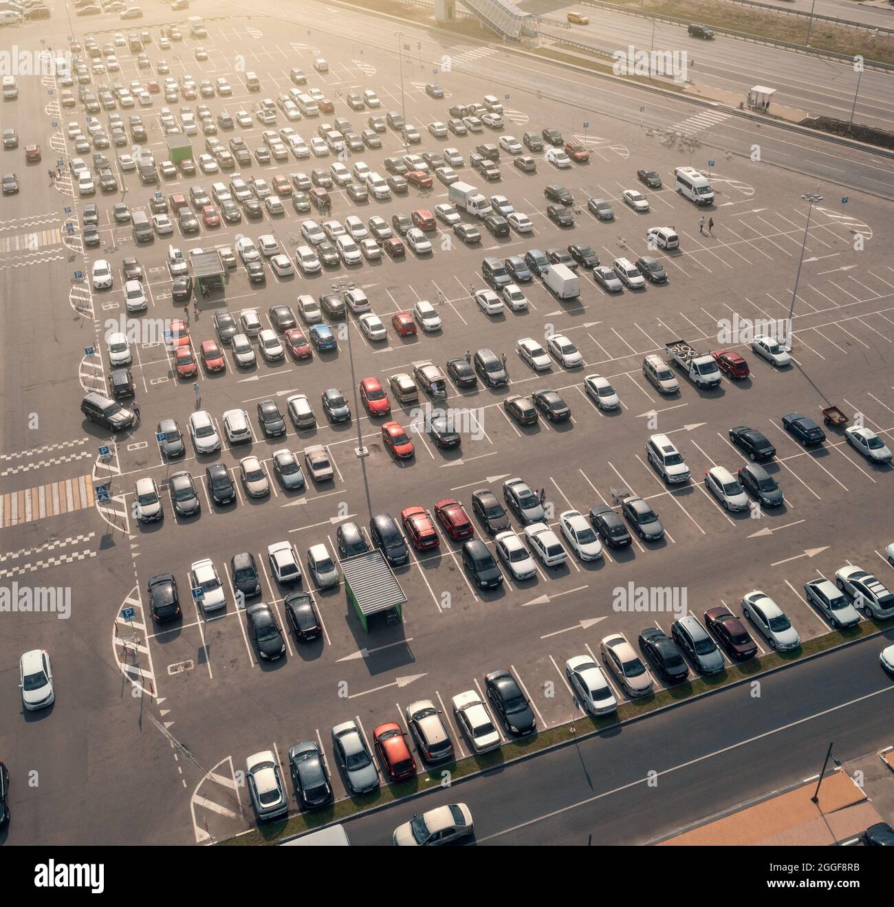 Parking lot with many parked cars at business center or mall, aerial ...