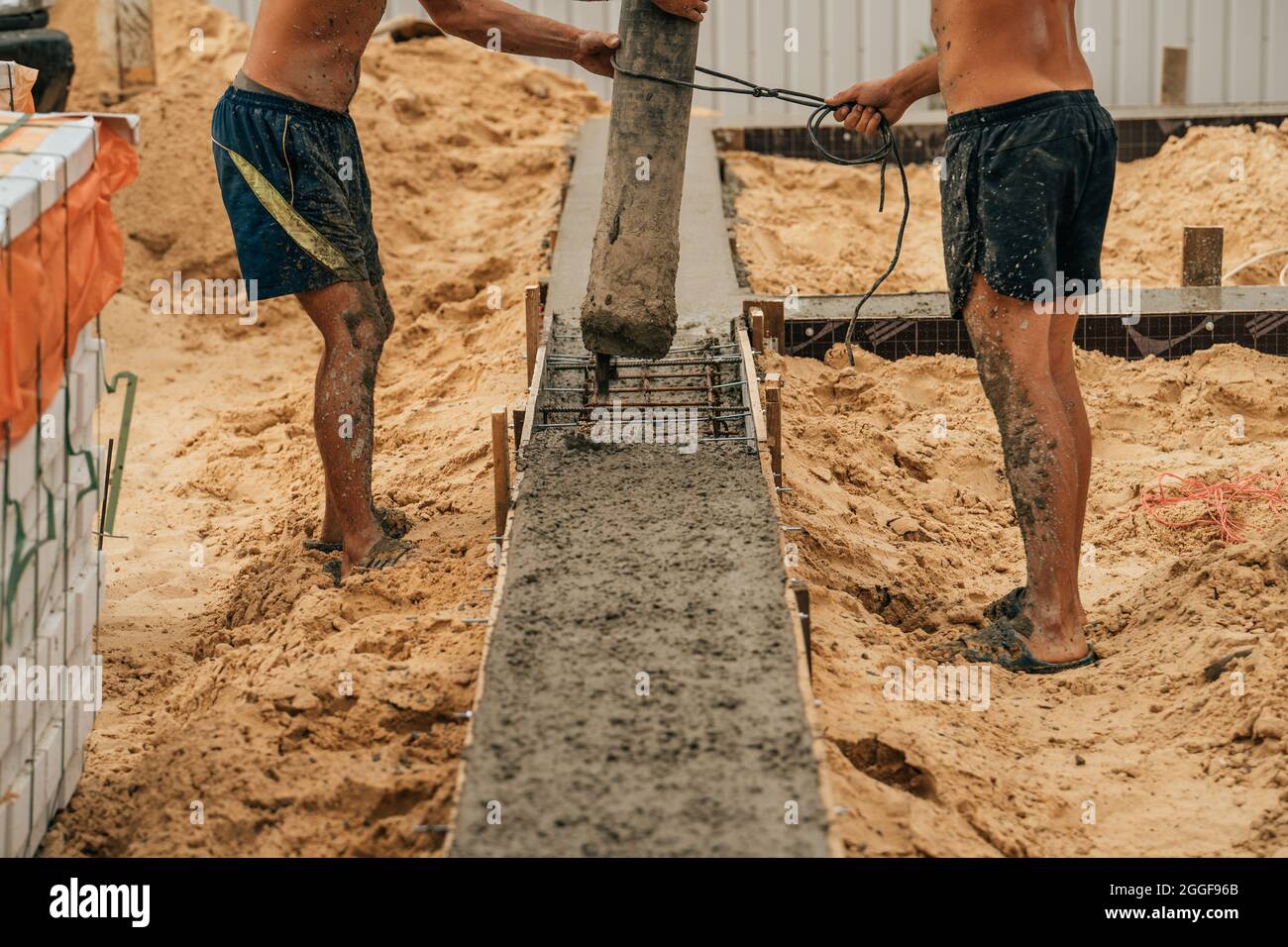 Pouring cement or concrete with automatic pump, construction site with ...