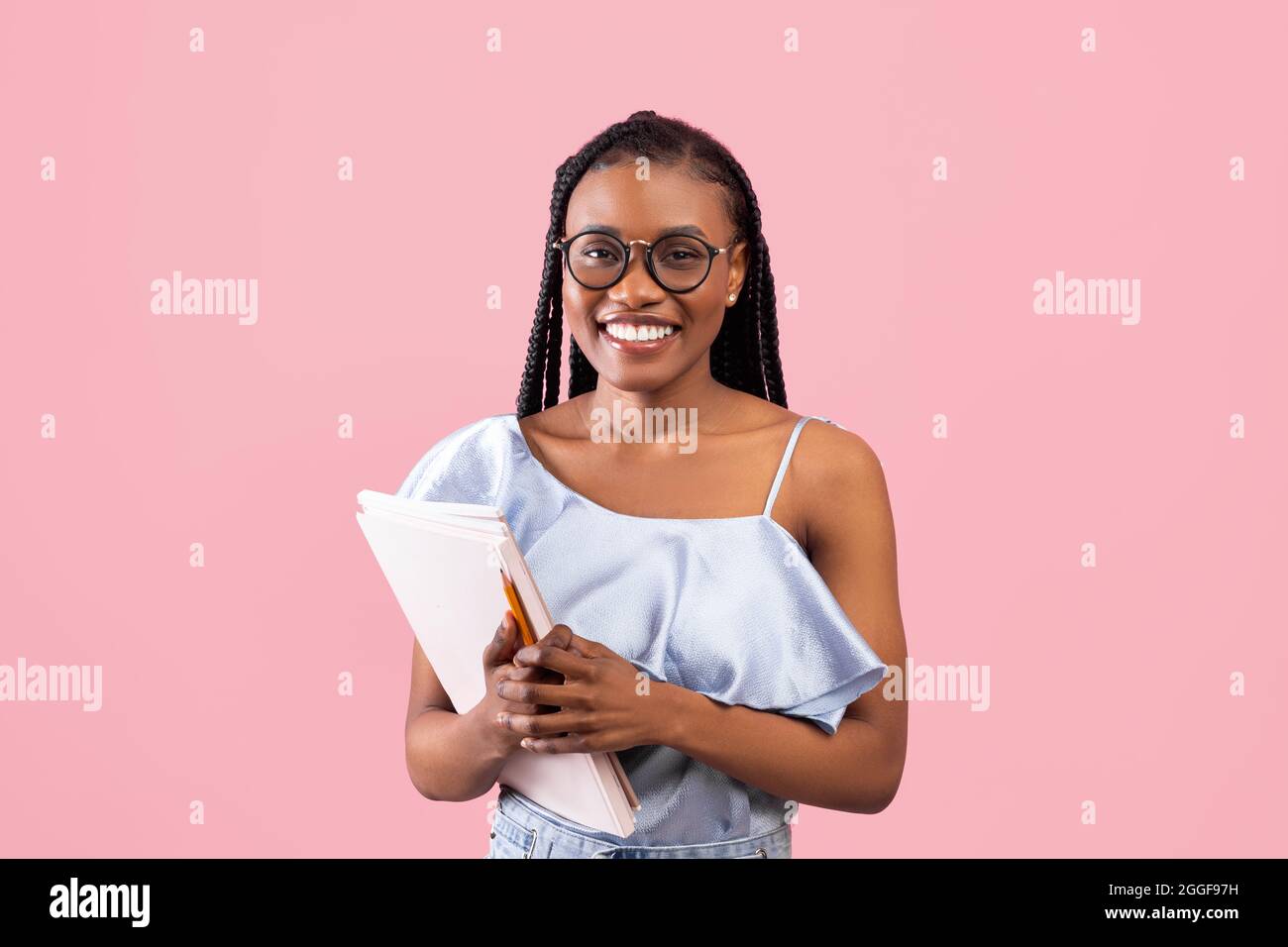 Back to school. Young black female student with book and notebooks ...