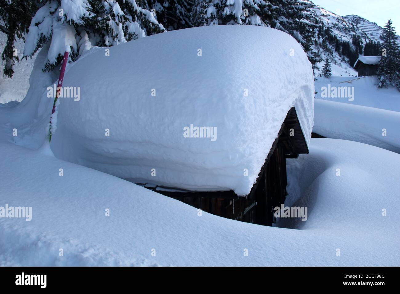 Small Cottage House with Huge Snow Stock Photo - Alamy