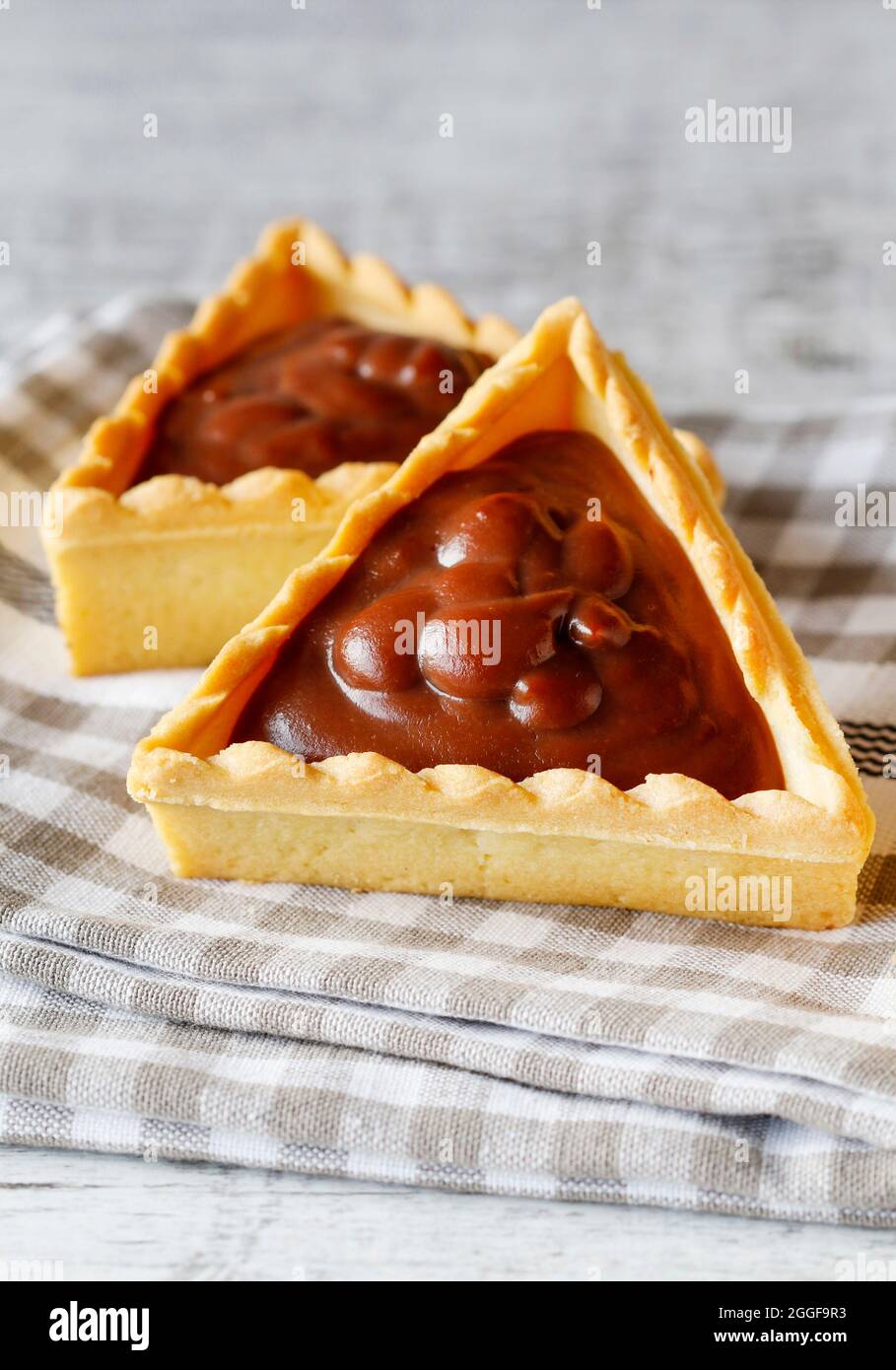 Chocolate triangles cakes. Party dessert Stock Photo - Alamy